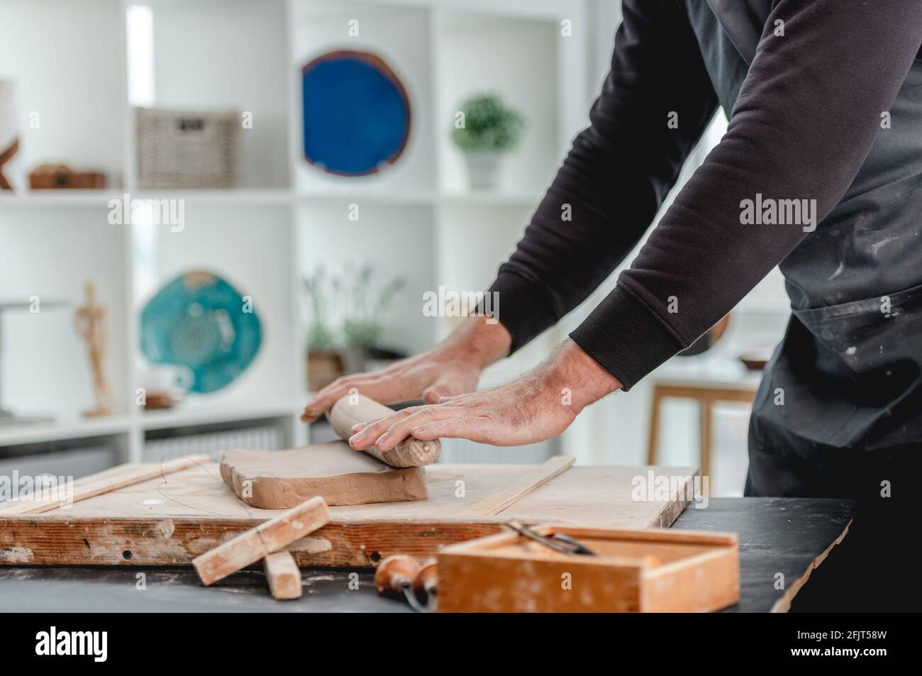 Man forming mold from pottery clay Stock Photo - Alamy