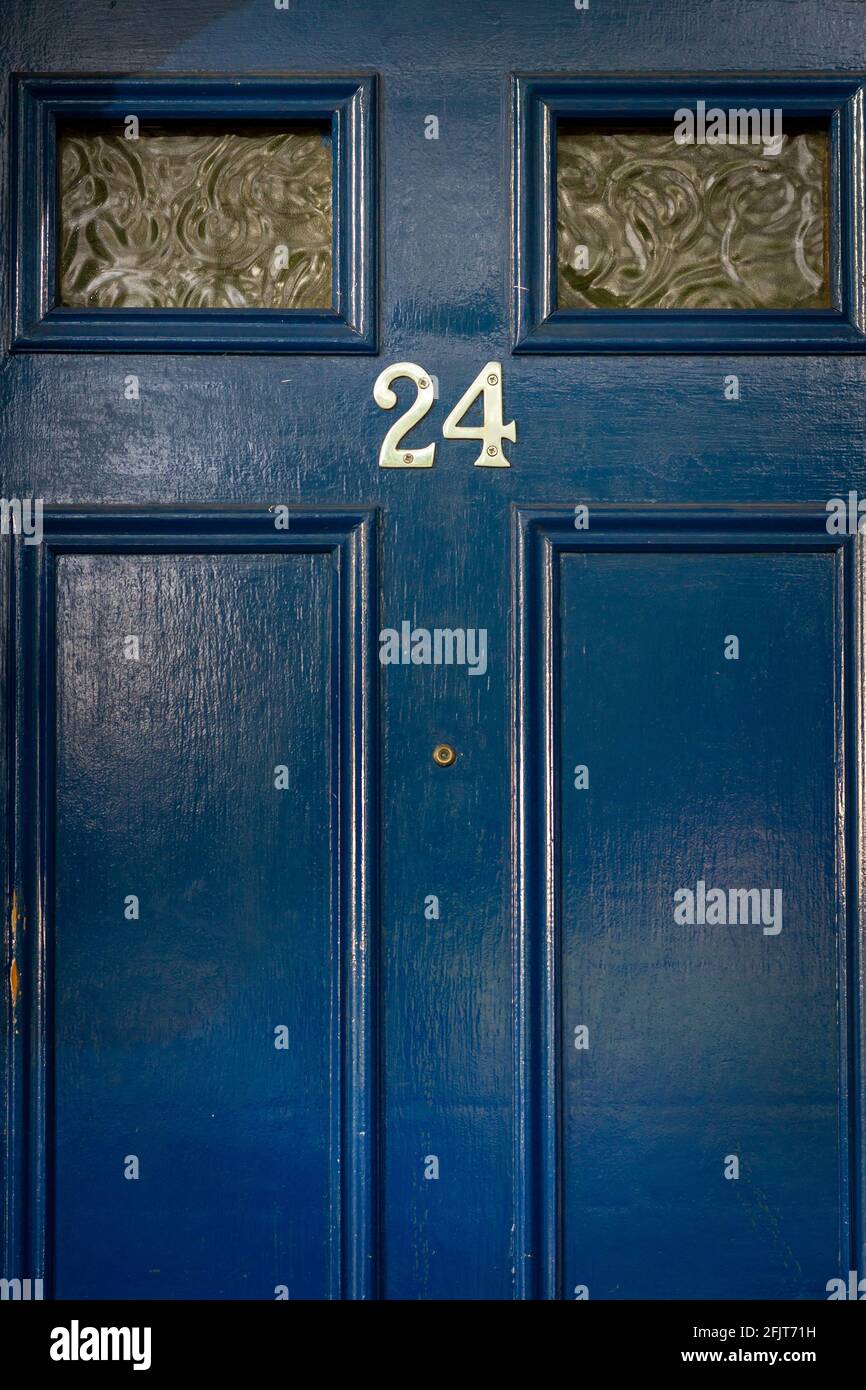 House number 24 on a blue wooden front door Stock Photo - Alamy