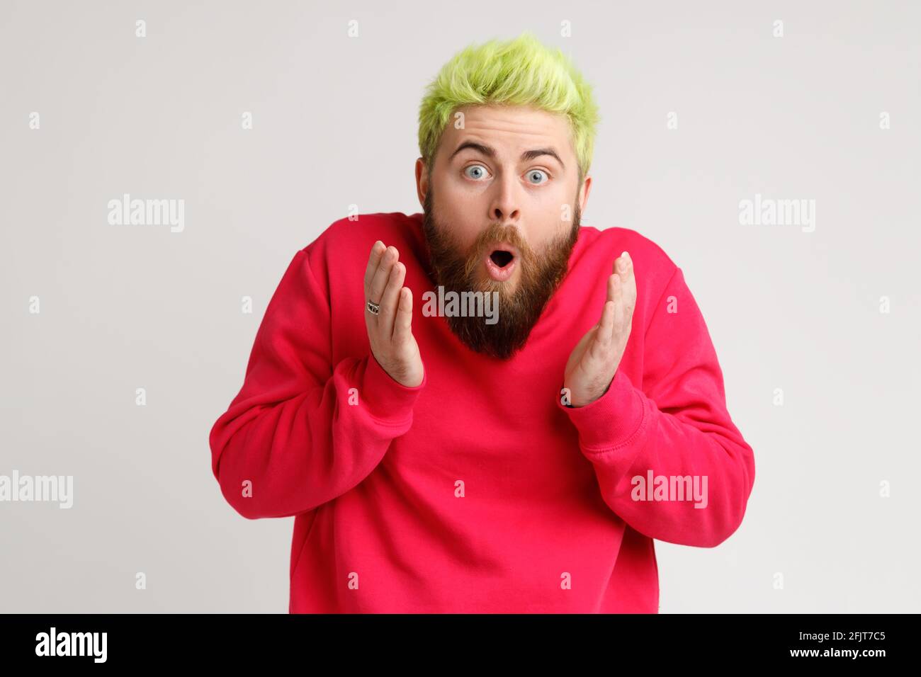 Photo of amazed shocked bearded young man with yellow hair, looks at ...