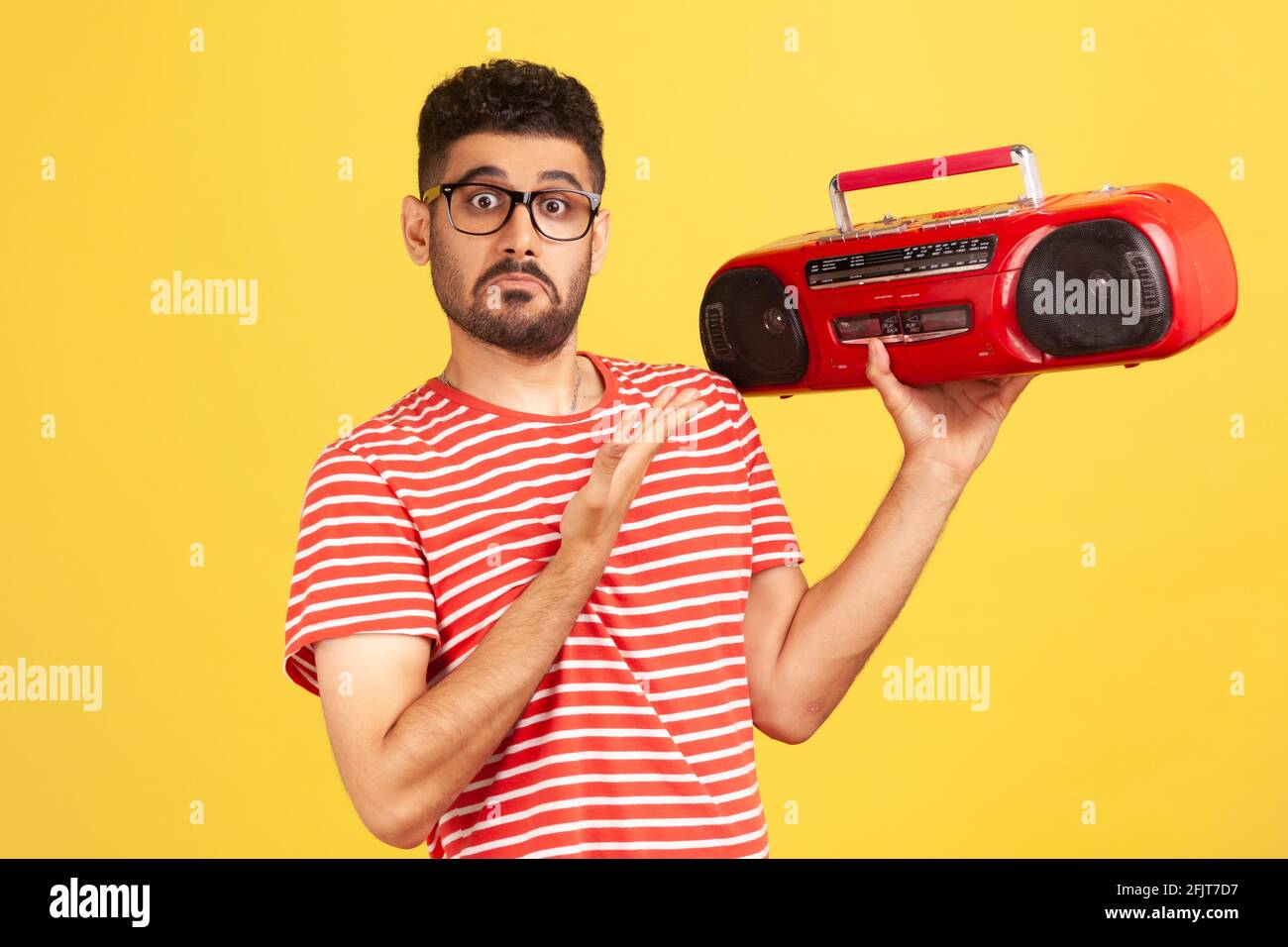 Confused funny man with beard and eyeglasses holding and showing ...