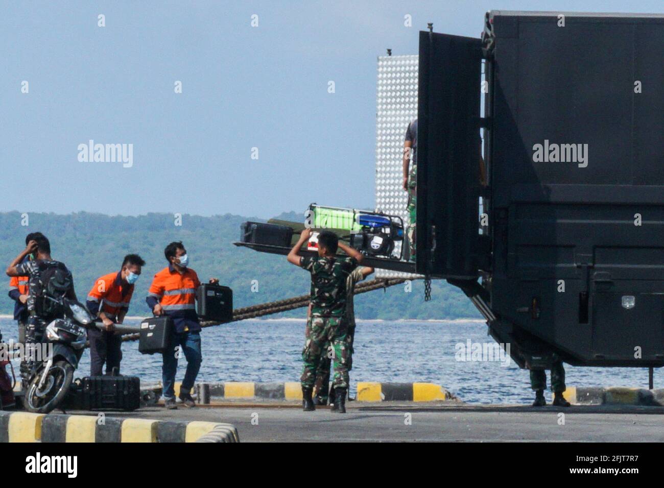 Jakarta, Indonesia. 26th Apr, 2021. Indonesian Navy members load ...