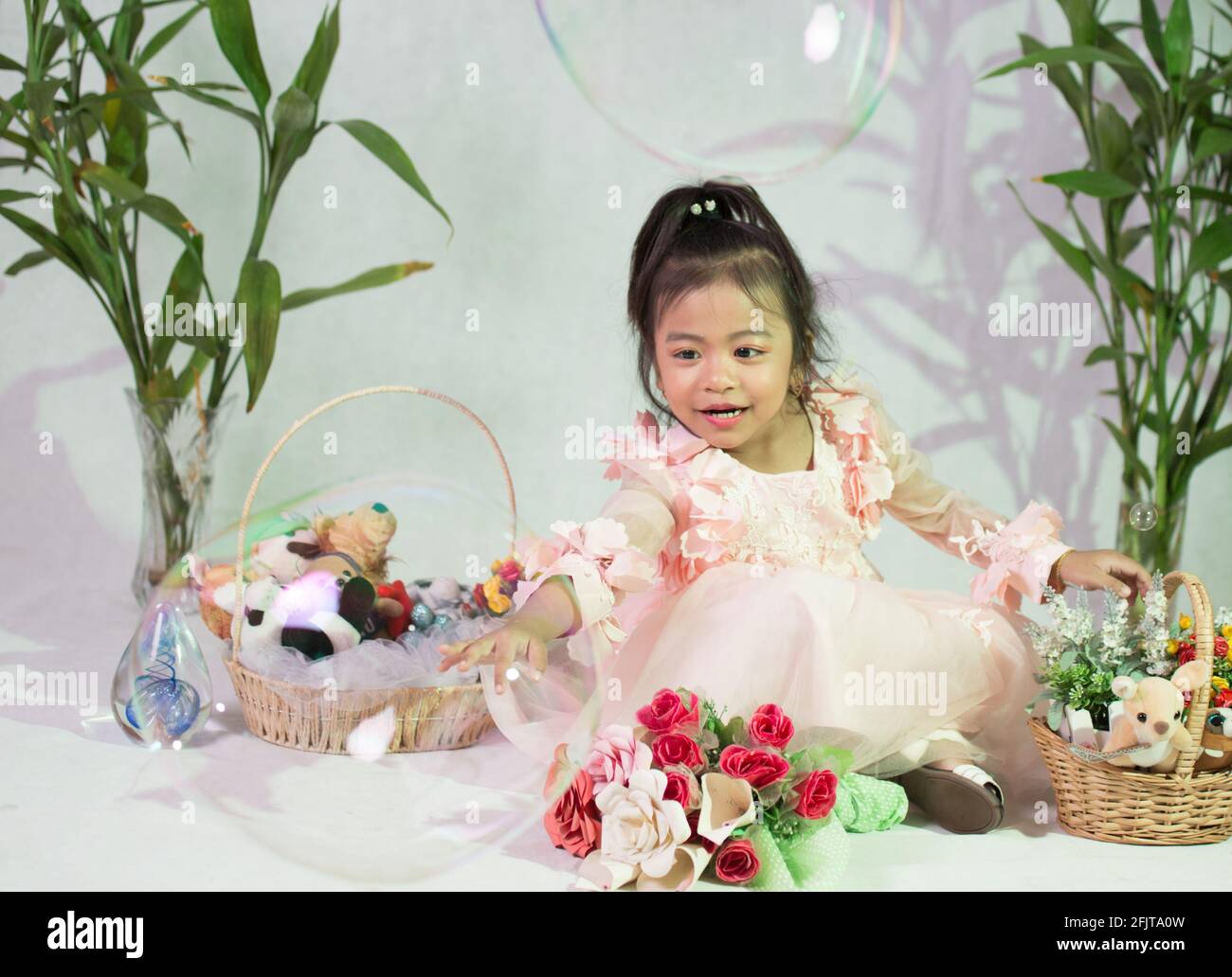 Asian cute little girl dressed in a pink-colored fashion dress Stock ...