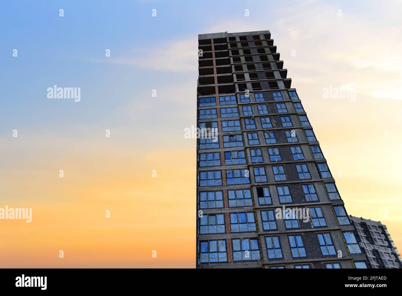 Facade of an unfinished high-rise residential building during ...