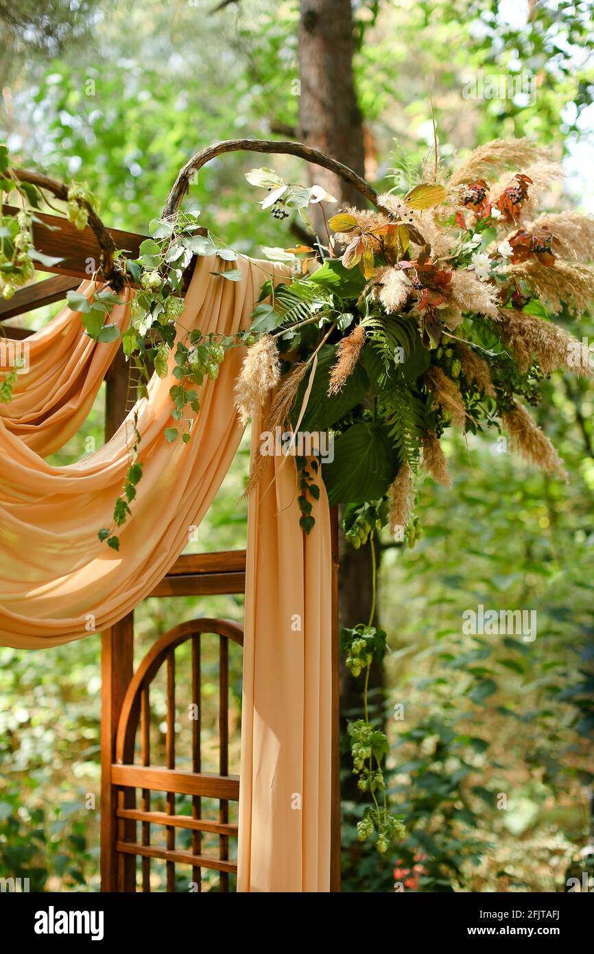 Yellow wonderful decorated wedding altar in park Stock Photo - Alamy