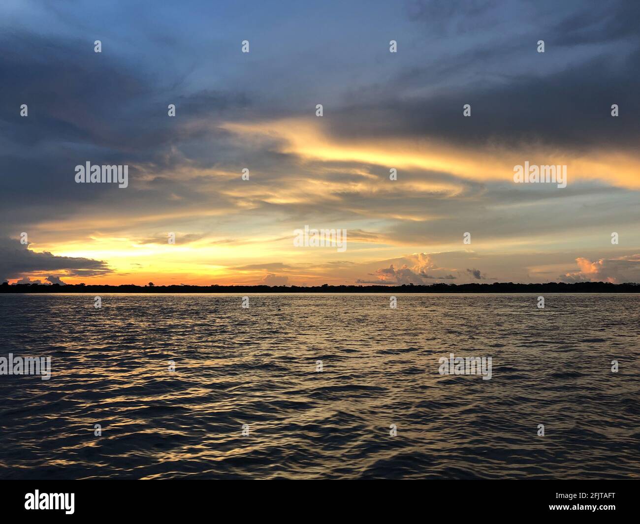 Sunset in amazon river from a canoe Stock Photo - Alamy