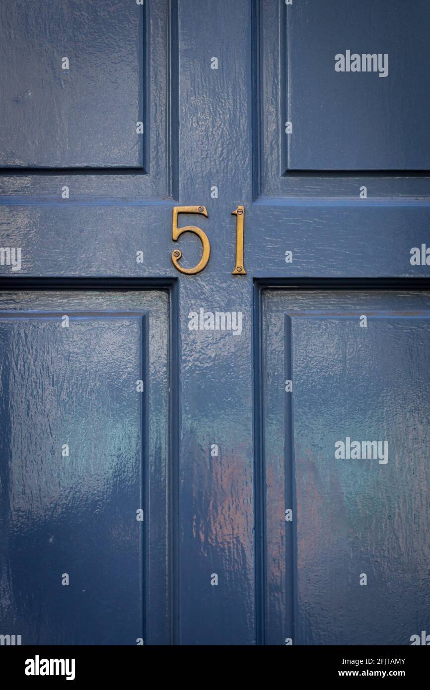 House number 51 on a blue wooden front door in golden metal digits ...