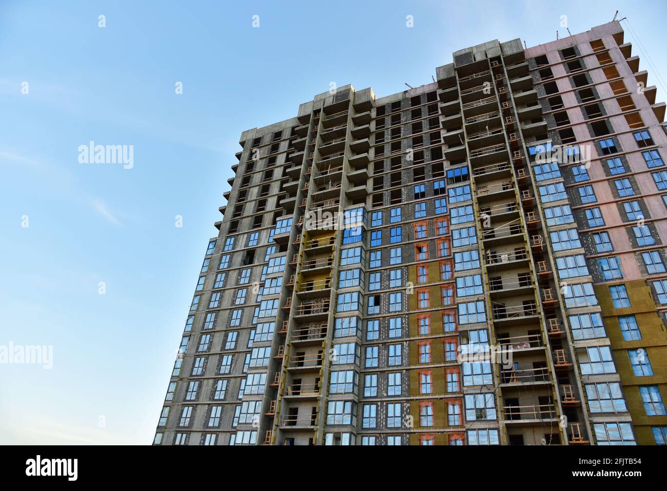 Facade of an unfinished high-rise residential building during ...
