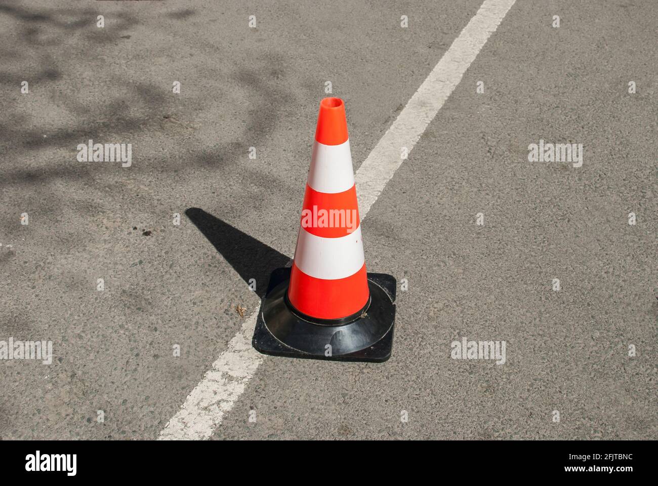 Traffic signal cone on asphalt road surface Stock Photo - Alamy