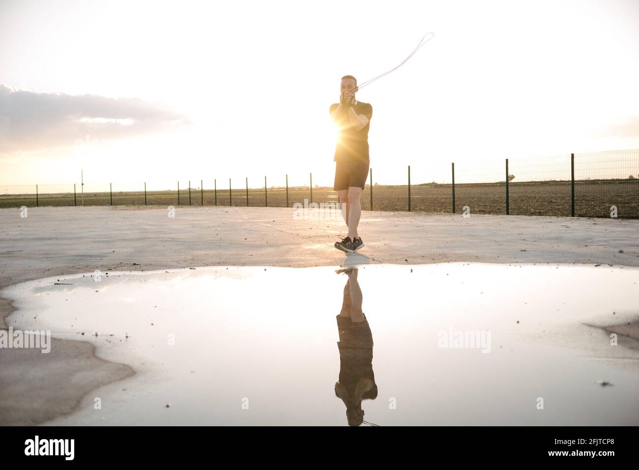 Concept: sport. Athlete man outdoors. Jumping rope. playing and having ...