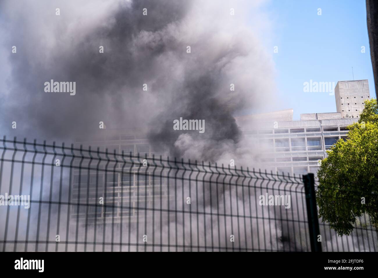 Red Firefighter engine and firefighter putting out huge fire Stock ...