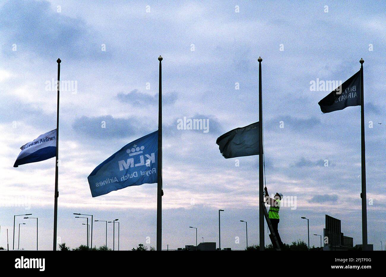 AIRLINE FLAGS BEING ADJUSTED TO HALF MAST AT HEATHROW. 12/9/01 PILSTON ...
