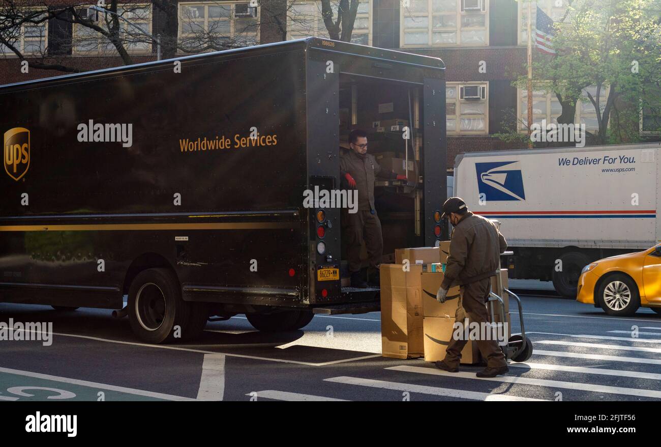 Deliverymen from UPS sort packages in the Chelsea neighborhood of New ...