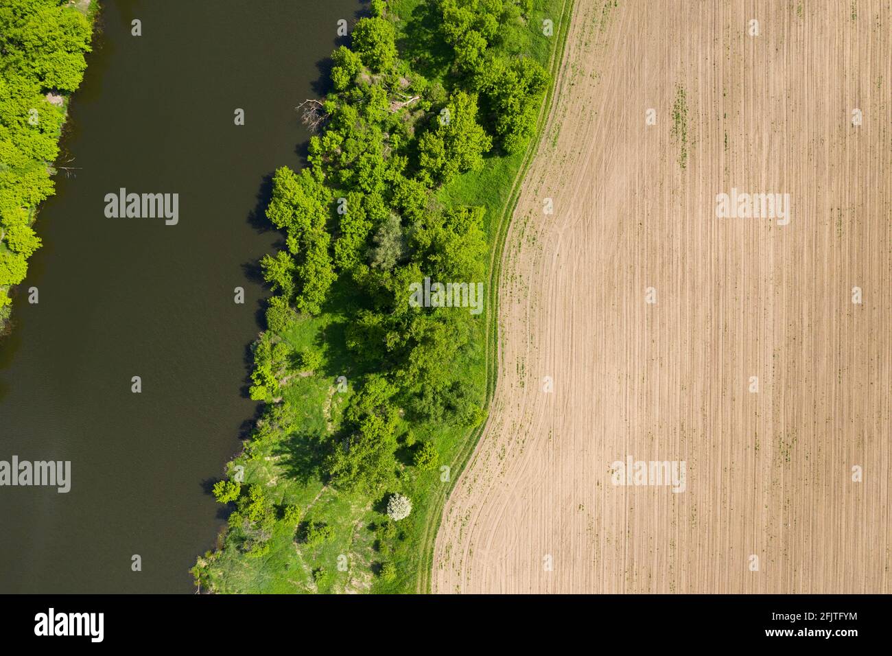 Empty agricultural field near the river prepared for sowing seeding in ...