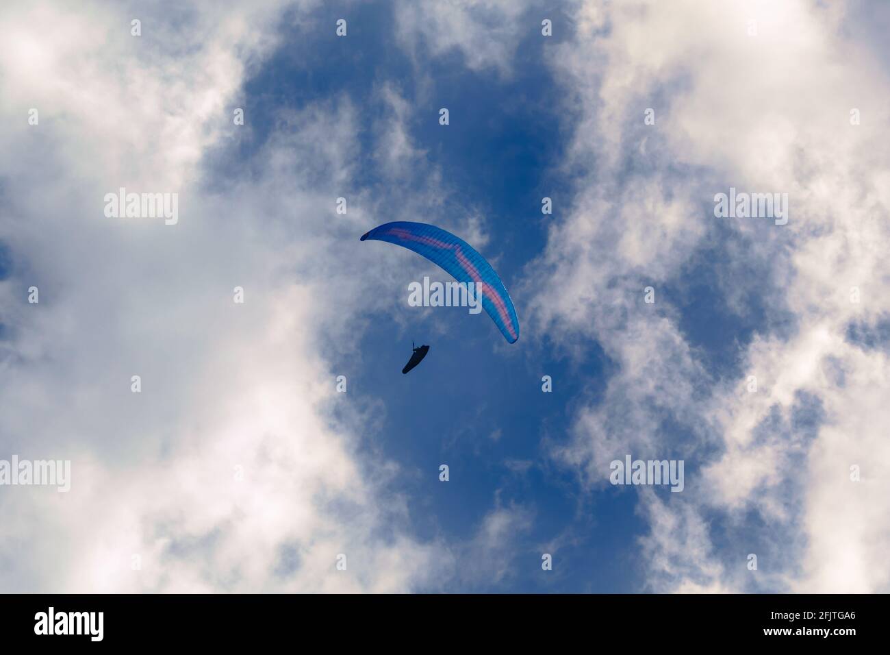 View from below of the flight of the paraglider against the background ...