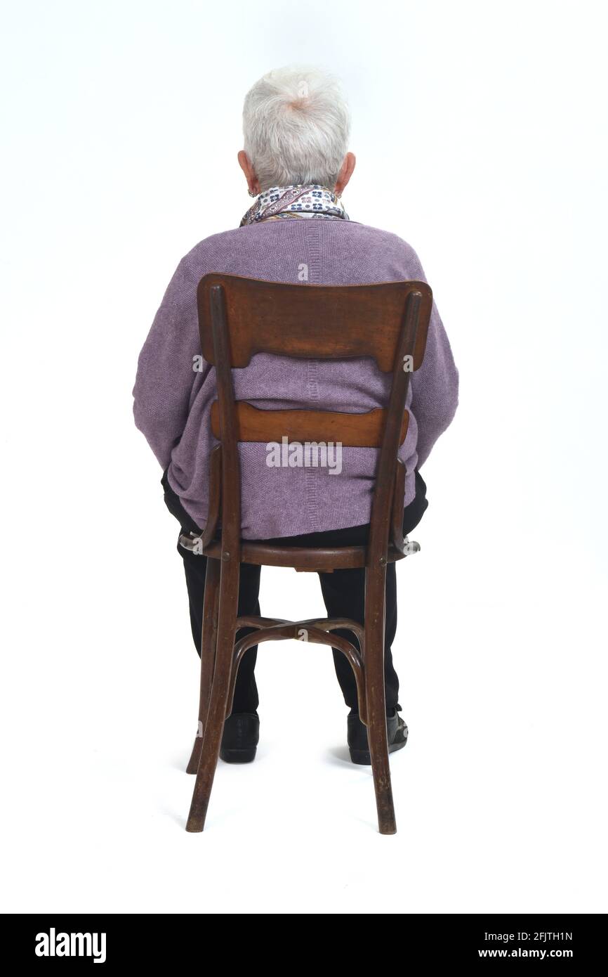 rear view of a senir woman sitting on chair on white background Stock ...