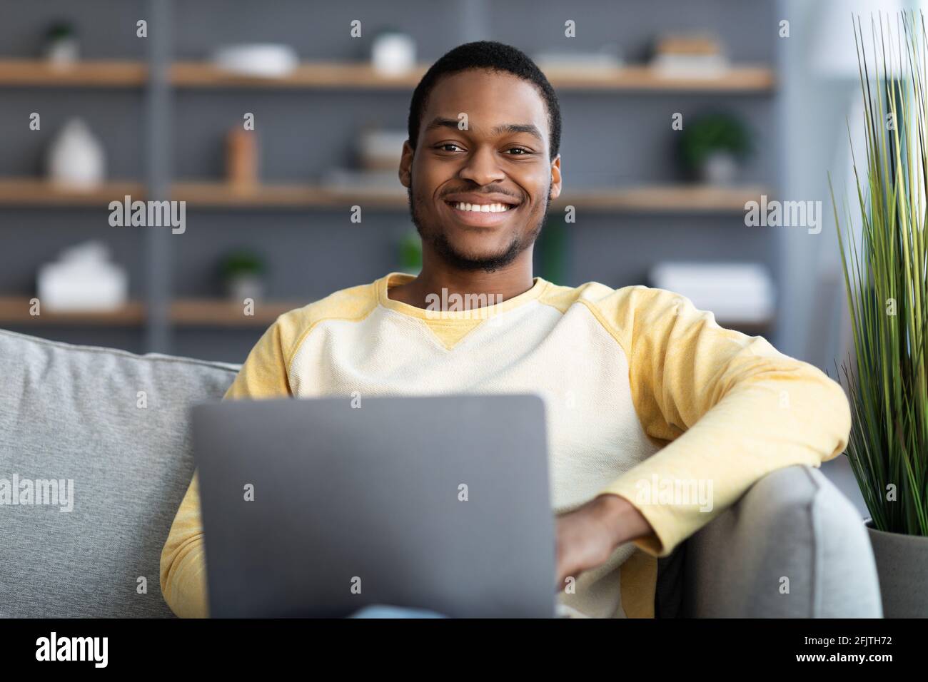 Cheerful black guy watching hi-res stock photography and images - Alamy