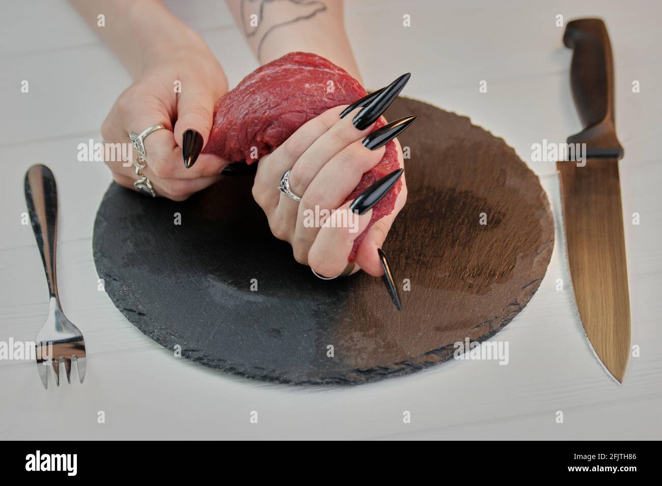 Woman eat raw meat hi-res stock photography and images - Alamy