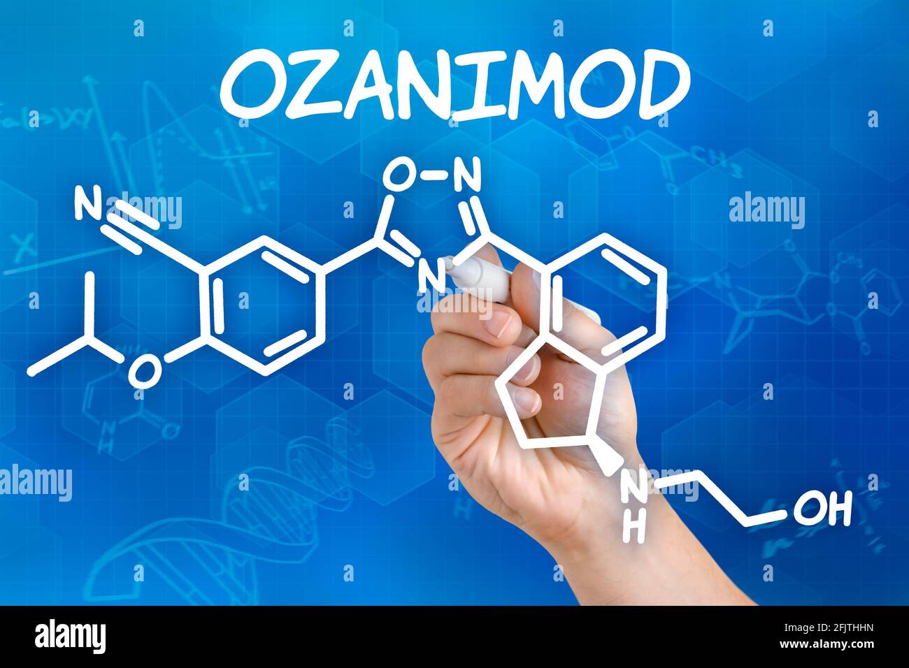 Hand with pen drawing the chemical formula of Ozanimod Stock Photo - Alamy