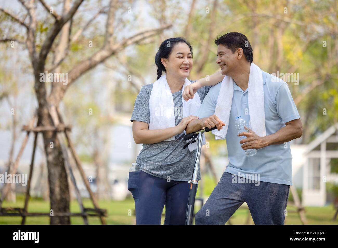 Couple workout and exercise with scooter together outdoor in park Stock ...