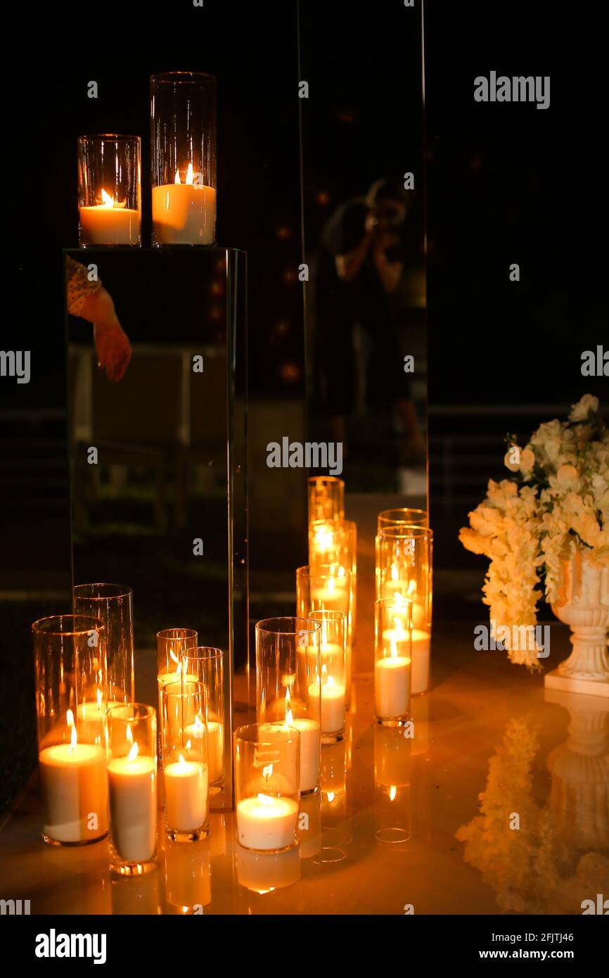 Burning candles near bouquet of flowers at night Stock Photo - Alamy