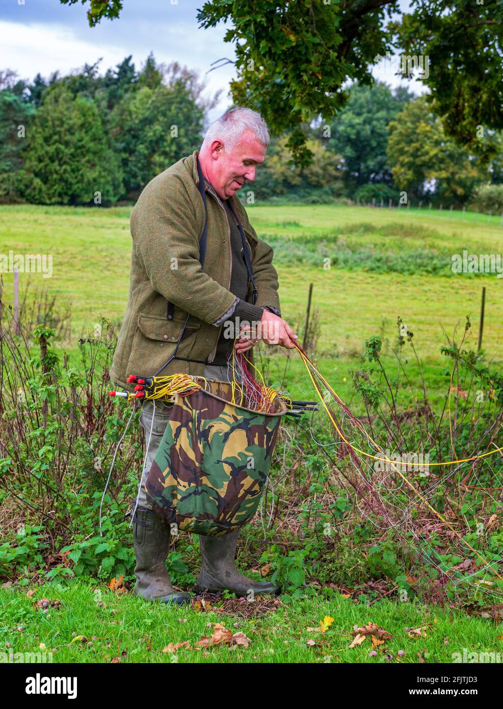 Kent, England, UK - A pest controller and warrener, working with a long ...