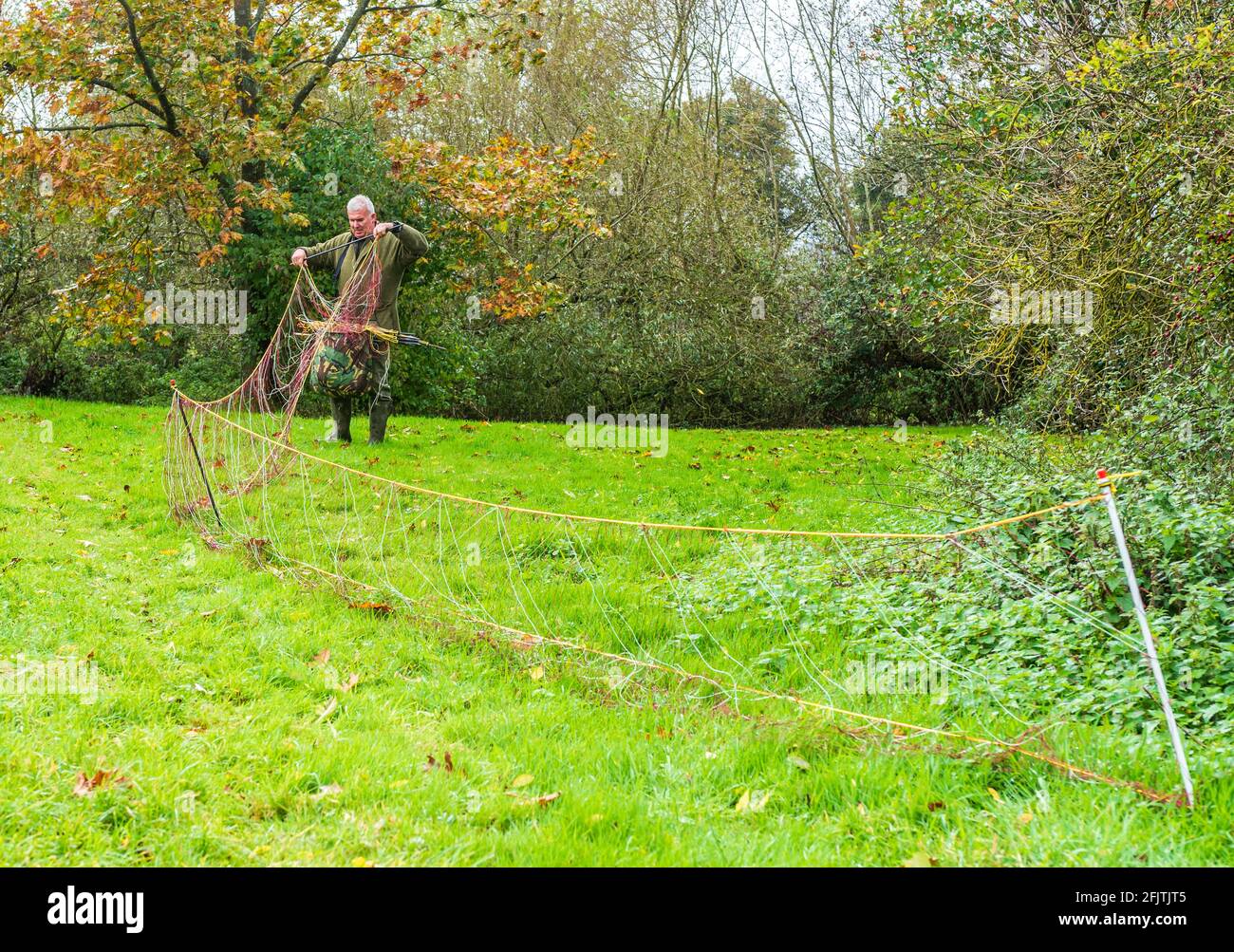 Kent, England, UK - A pest controller and warrener, working with a long ...