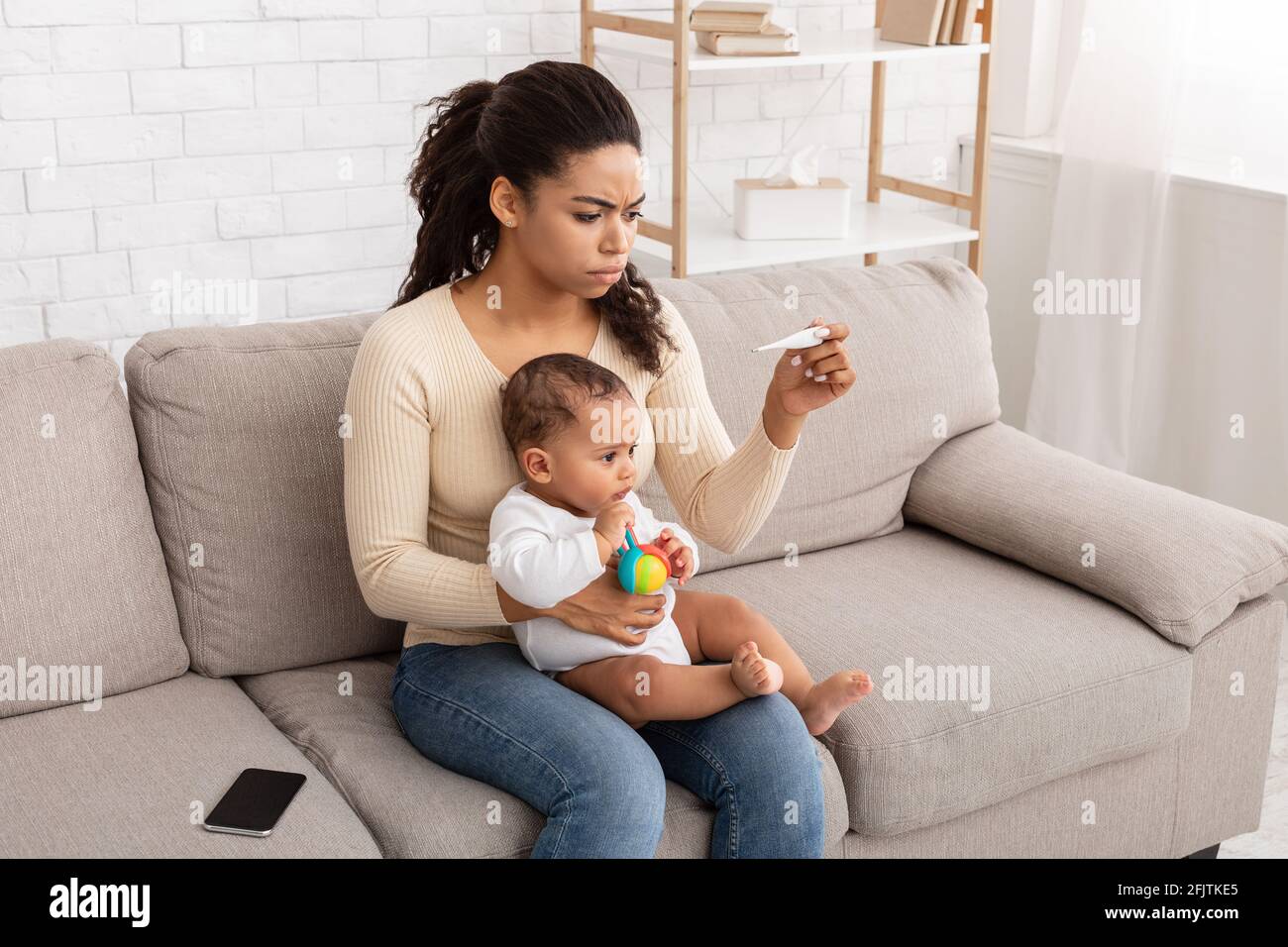 Black Mom Measuring Temperature For Sick Baby Having Fever Indoor Stock ...