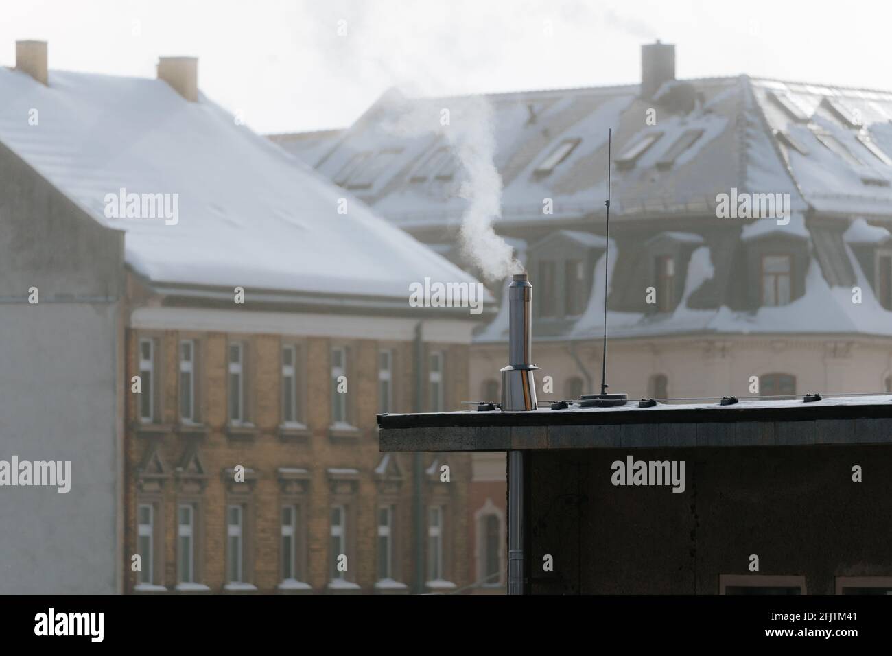 smoke of chimney on rooftop in city Stock Photo - Alamy