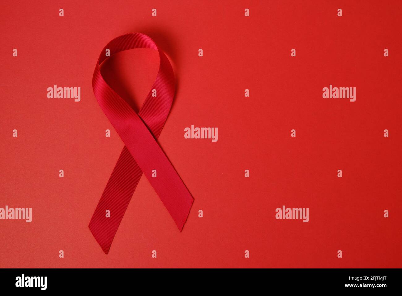 Red ribbon on red background is symbol of AIDS and drug addiction Stock ...