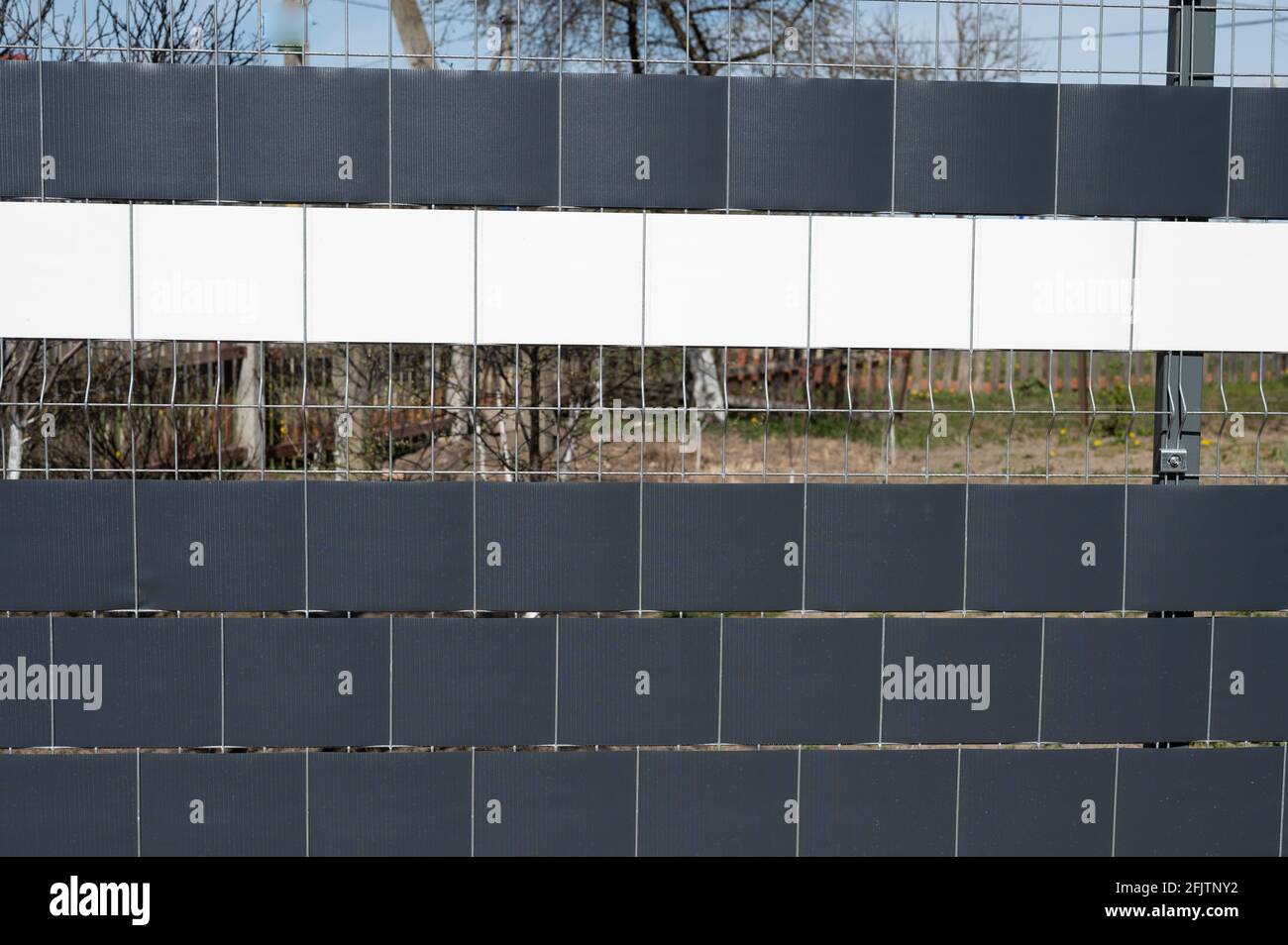 metal fence made of square pieces of metal Stock Photo - Alamy