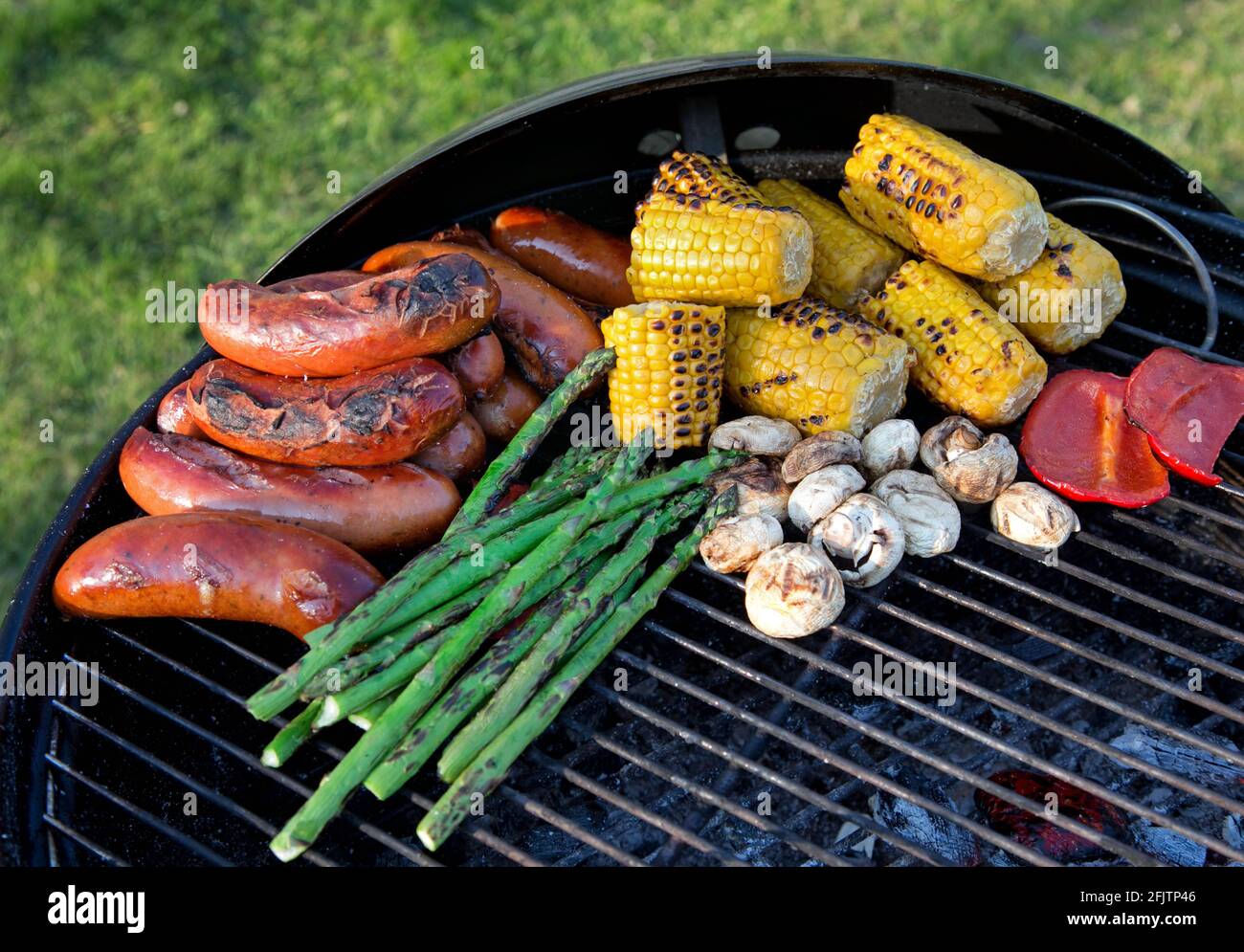 Barbecue time with sausages, corn, asparagus, mushrooms and peppers ...
