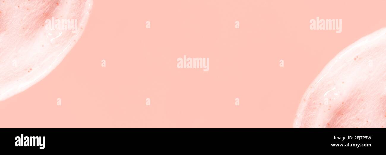 The texture of a scrub or shower gel on a pink background. Copy spase ...