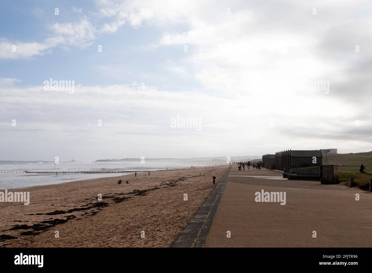 Blyth Beach in Northumberland, England. Beach huts overlook the sandy ...