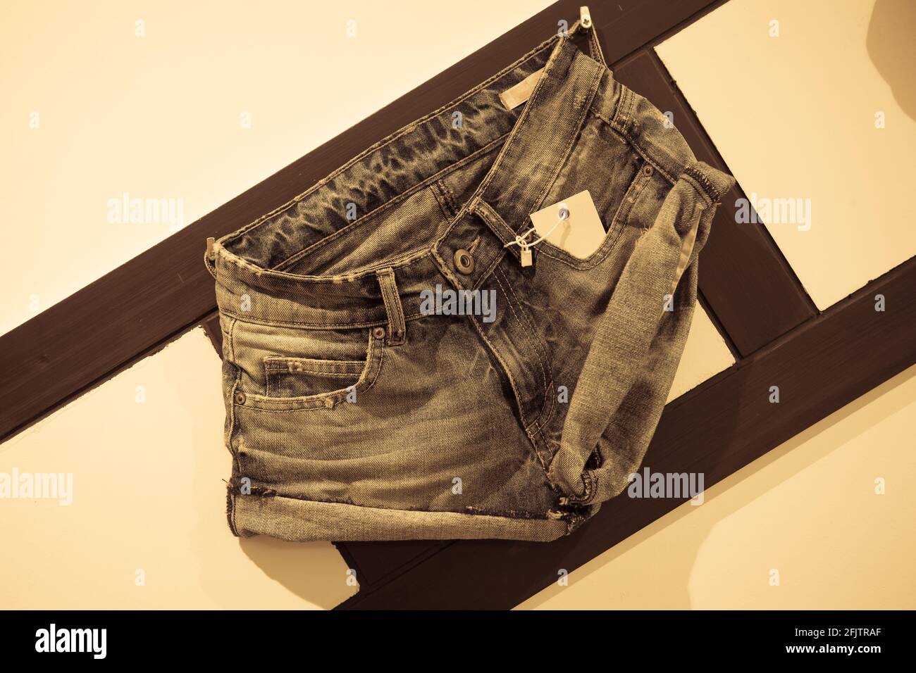Rolled up Jeans knickers for girls on display Stock Photo - Alamy