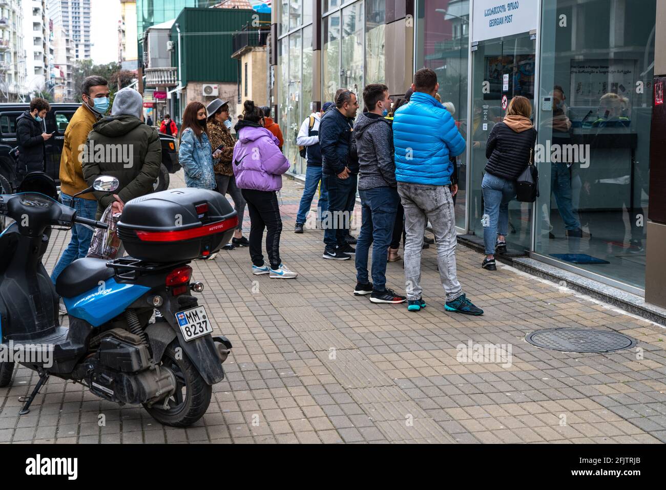 Batumi, Georgia - February 8, 2021: People wait in line at the post ...