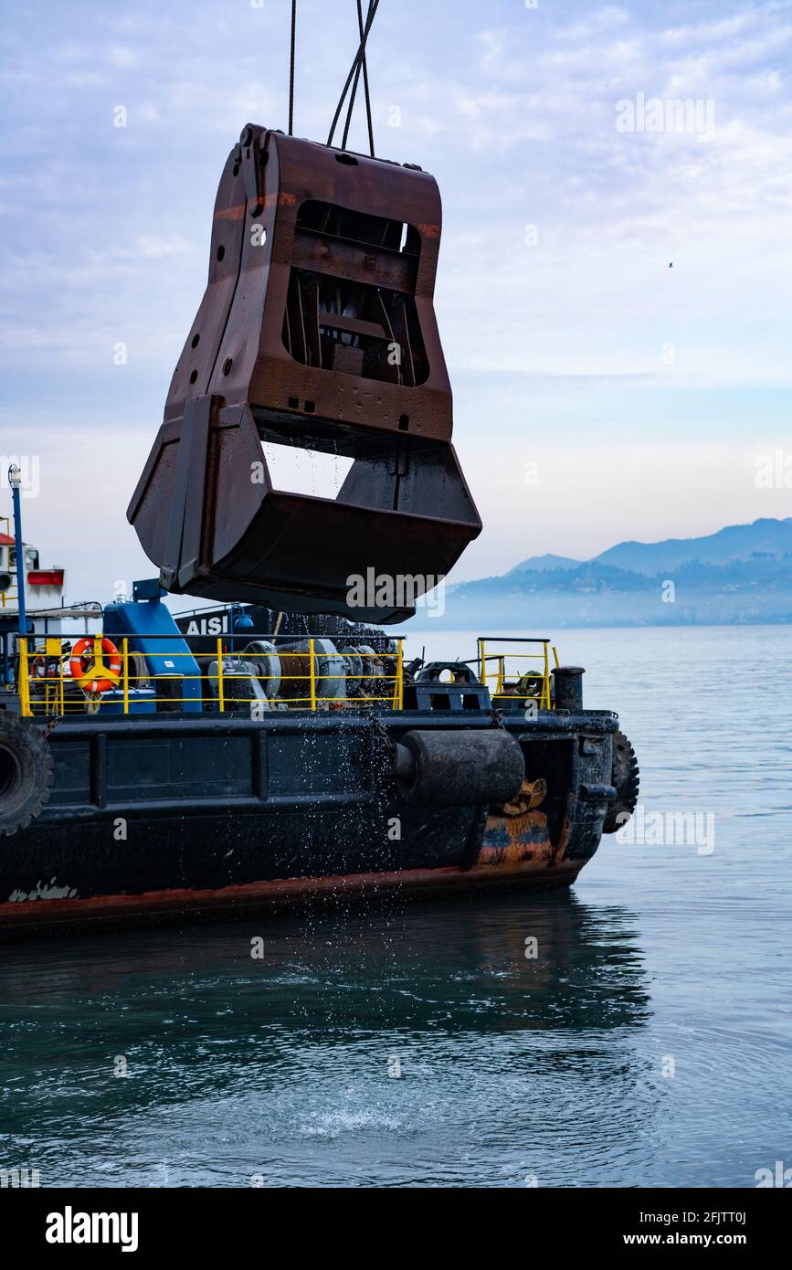 Batumi, Georgia - 08 February 2021: Launched floating excavator with ...