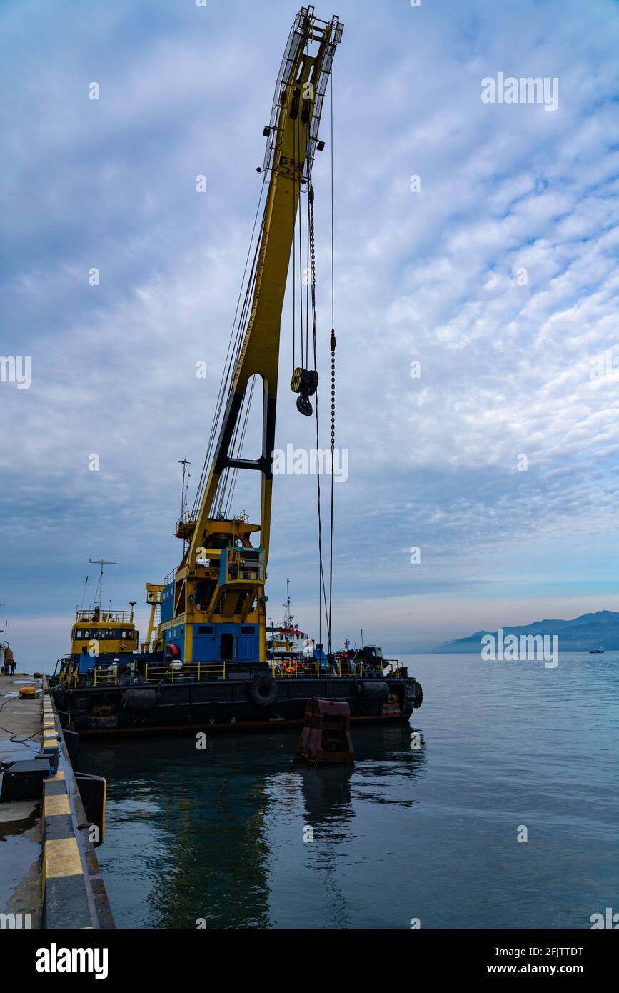 Batumi, Georgia - 08 February 2021: Yellow crane in a cargo port ...