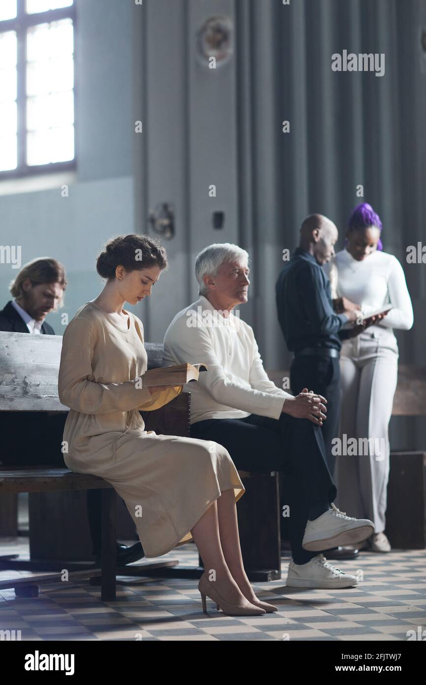 Group of people sitting on the bench and listening to mass in the ...