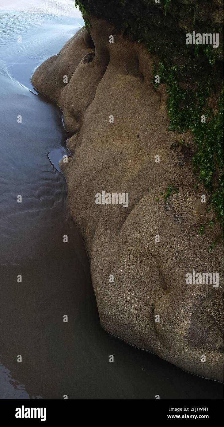 Two smiling human faces stone sculpture Stock Photo - Alamy