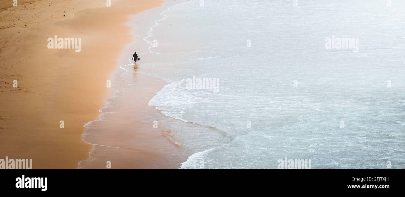 Aerial view of a person walking on the sand beach Stock Photo - Alamy