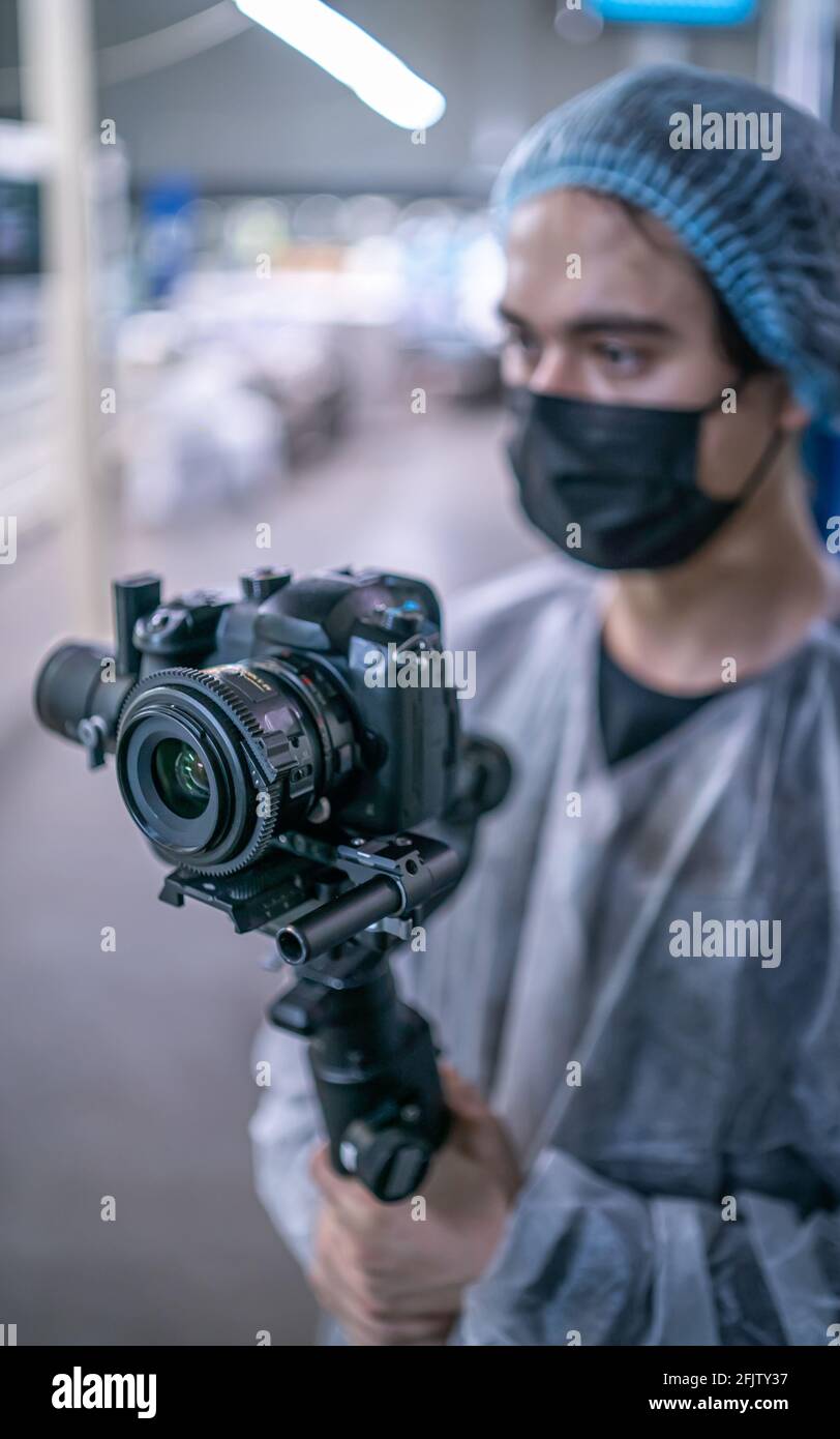 Young operator in medical protective suit with camera Stock Photo - Alamy