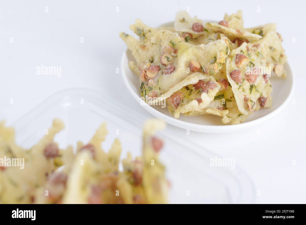 Peyek Kacang or peanut rempeyek in white background. Deep fried savoury ...