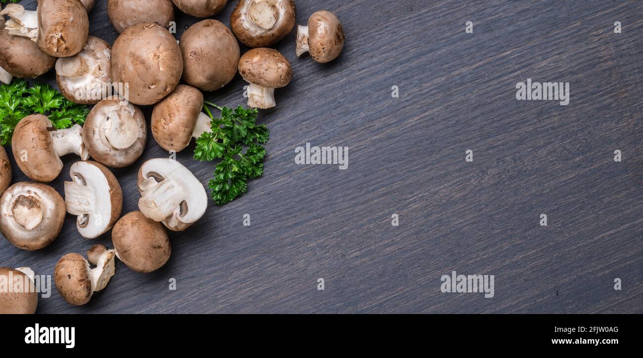 Brown colored edible mushrooms or cremini mushrooms on black table with ...