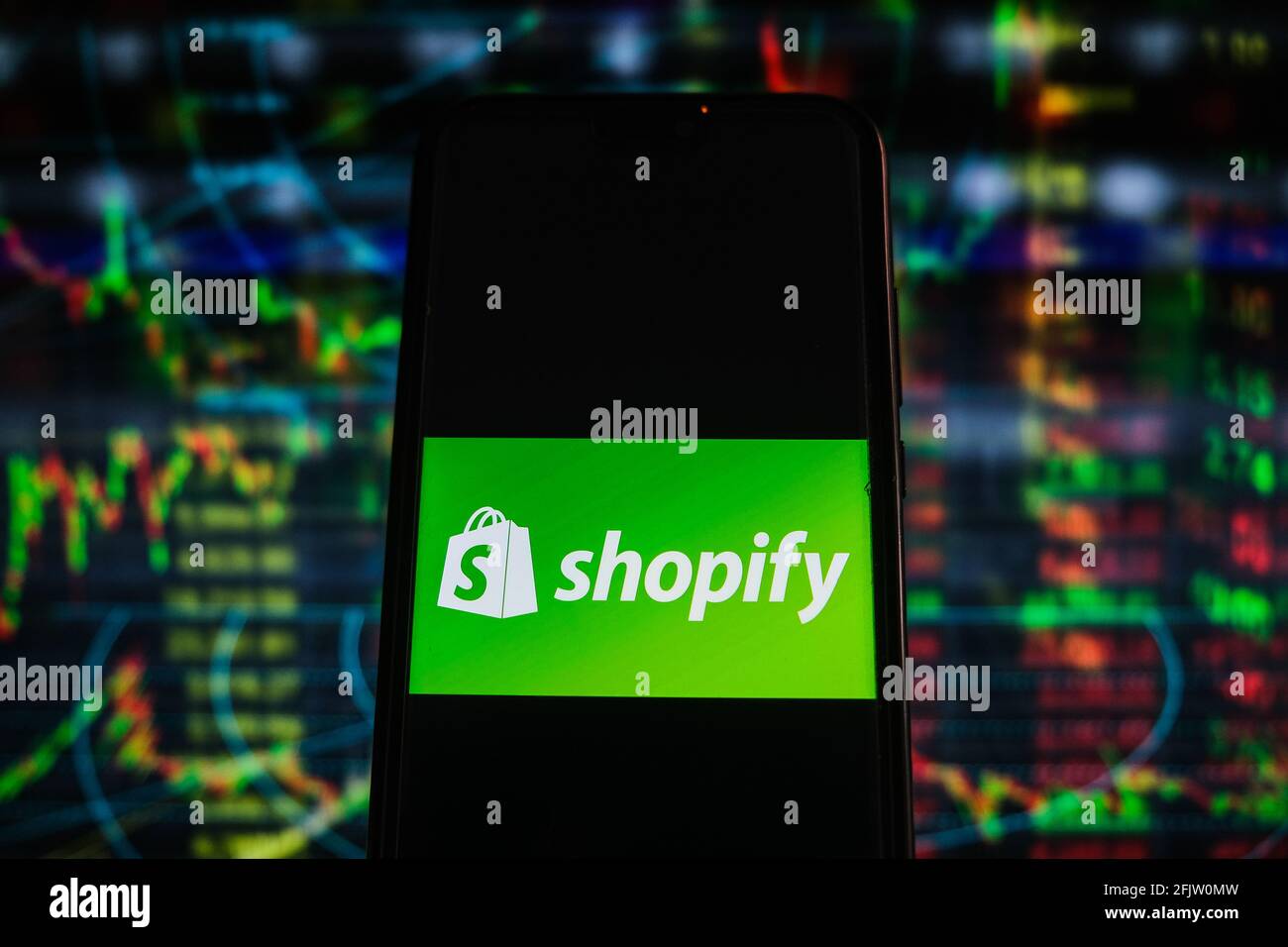 In this photo illustration a Shopify logo seen displayed on a ...