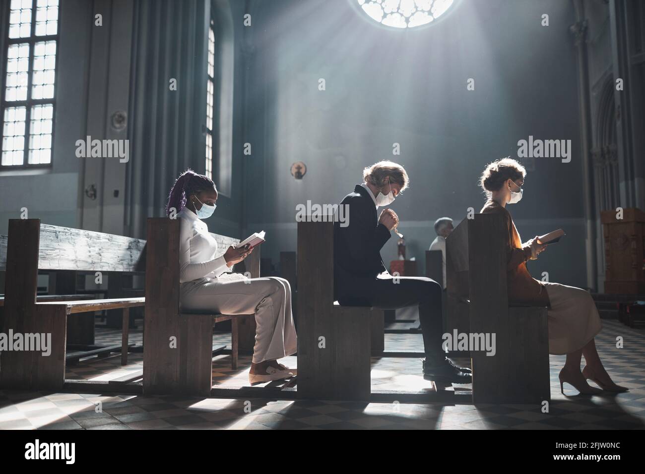 Group of people sitting on the bench and praying in old beautiful ...