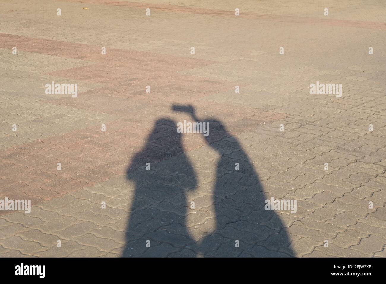 Shadow on The Floor of Two People Taking Photo By Smartphone Stock ...