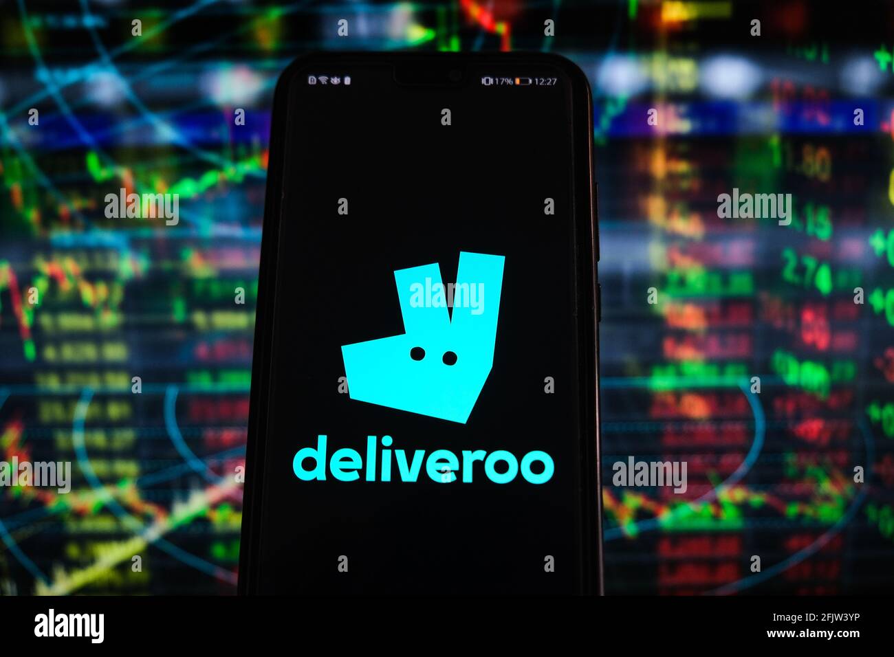 In this photo illustration a Deliveroo logo seen displayed on a ...