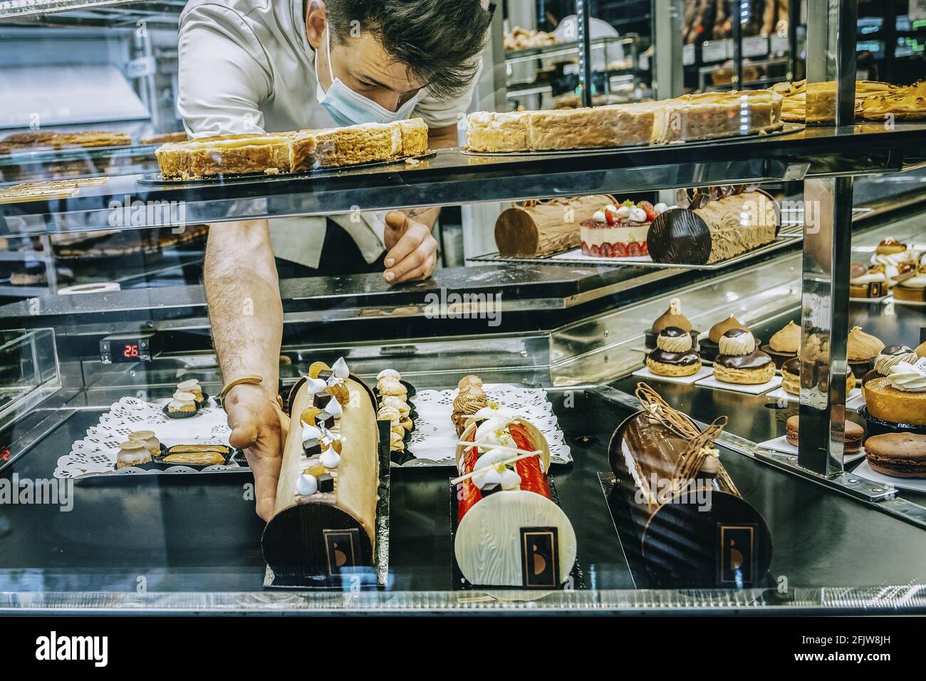 France, Paris, installation of Christmas logs in the window of a pastry ...