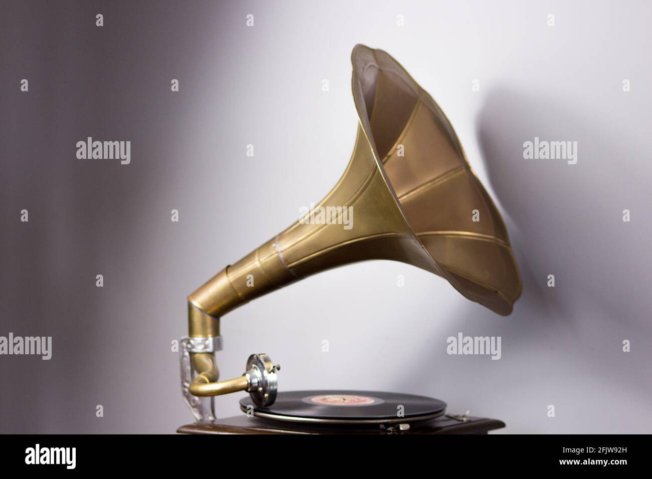 Old gramophone with a plate record. Portable wind-up gramophone ...