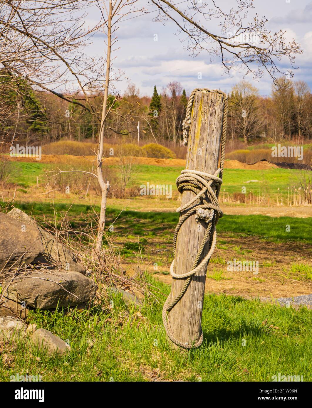 a rope tied around a post on a farm Stock Photo - Alamy